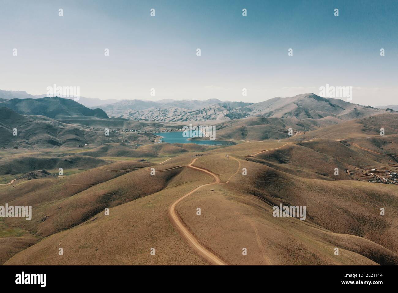 Aerial view of a path leading to an impressive mountain landscape in ...