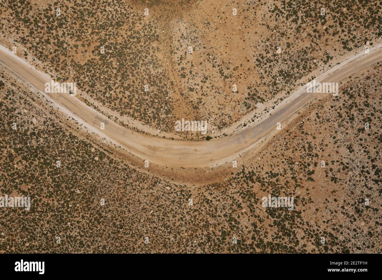 Aerial view of a path leading to an impressive mountain landscape in ...