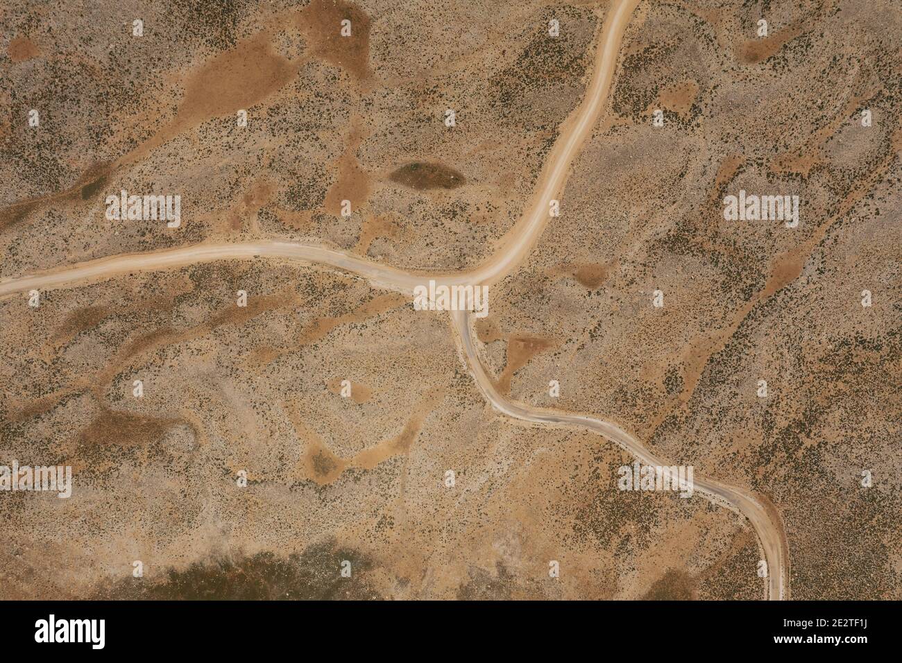 Aerial view of a path leading to an impressive mountain landscape in ...
