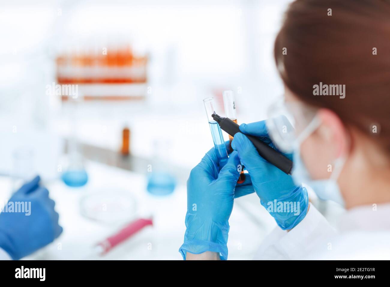 rear view . test tube in hands of the laboratory employee Stock Photo ...