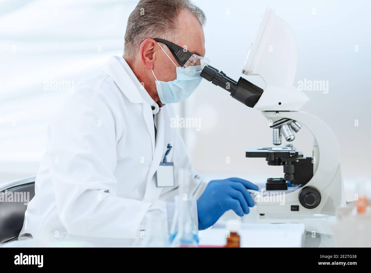 close up. scientist in a protective mask conducts research in the ...