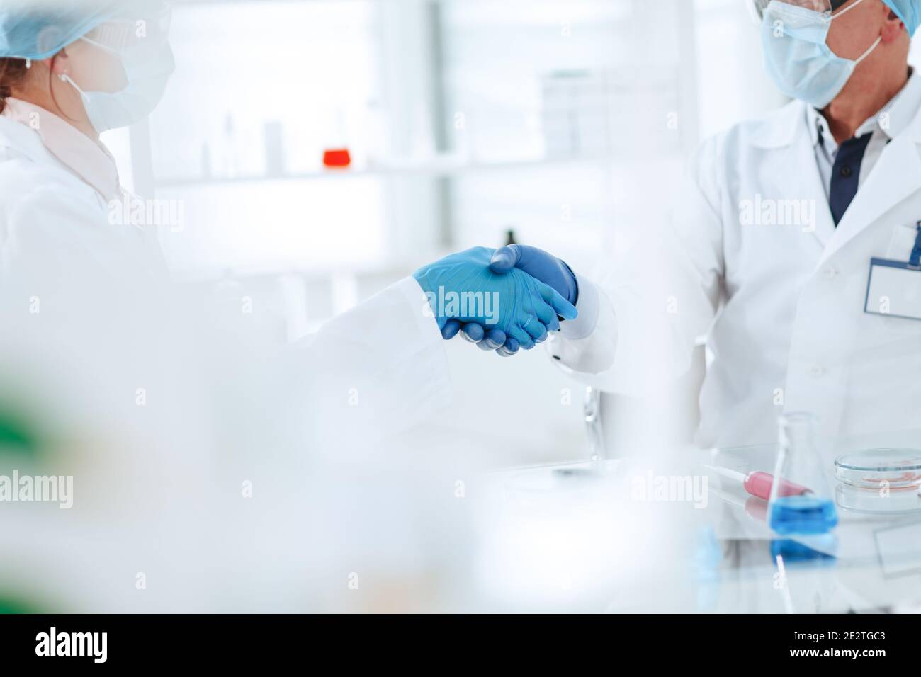 close up. scientists colleagues shaking hands with each other Stock ...