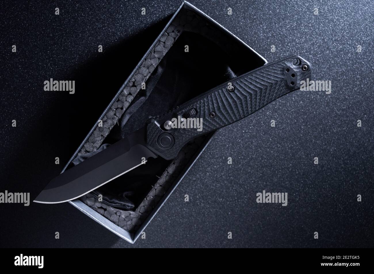 Knife in a cardboard box. Knife in a box on a black background. Falling ...