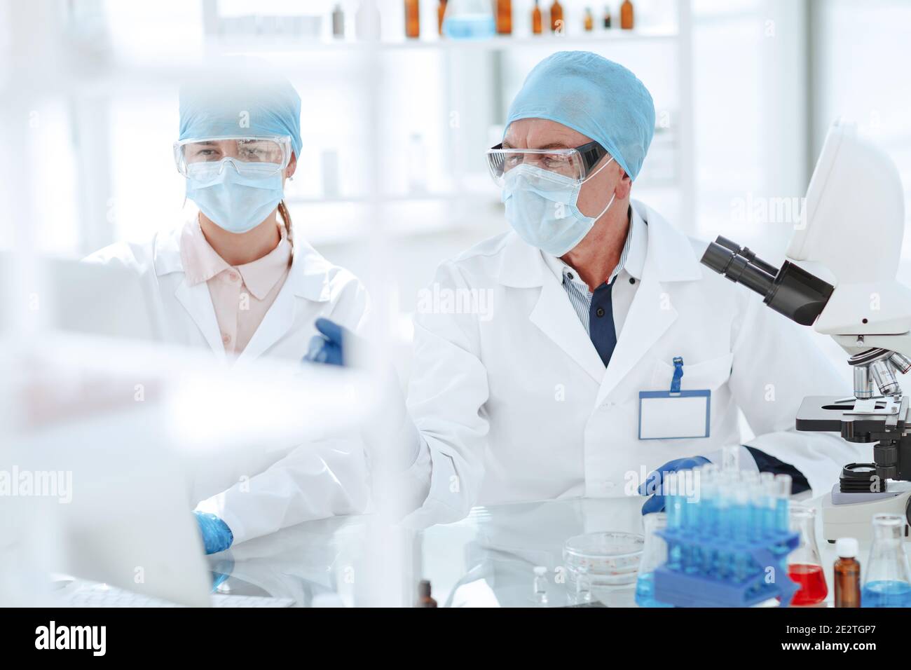 researchers discuss data from a computer monitor Stock Photo - Alamy