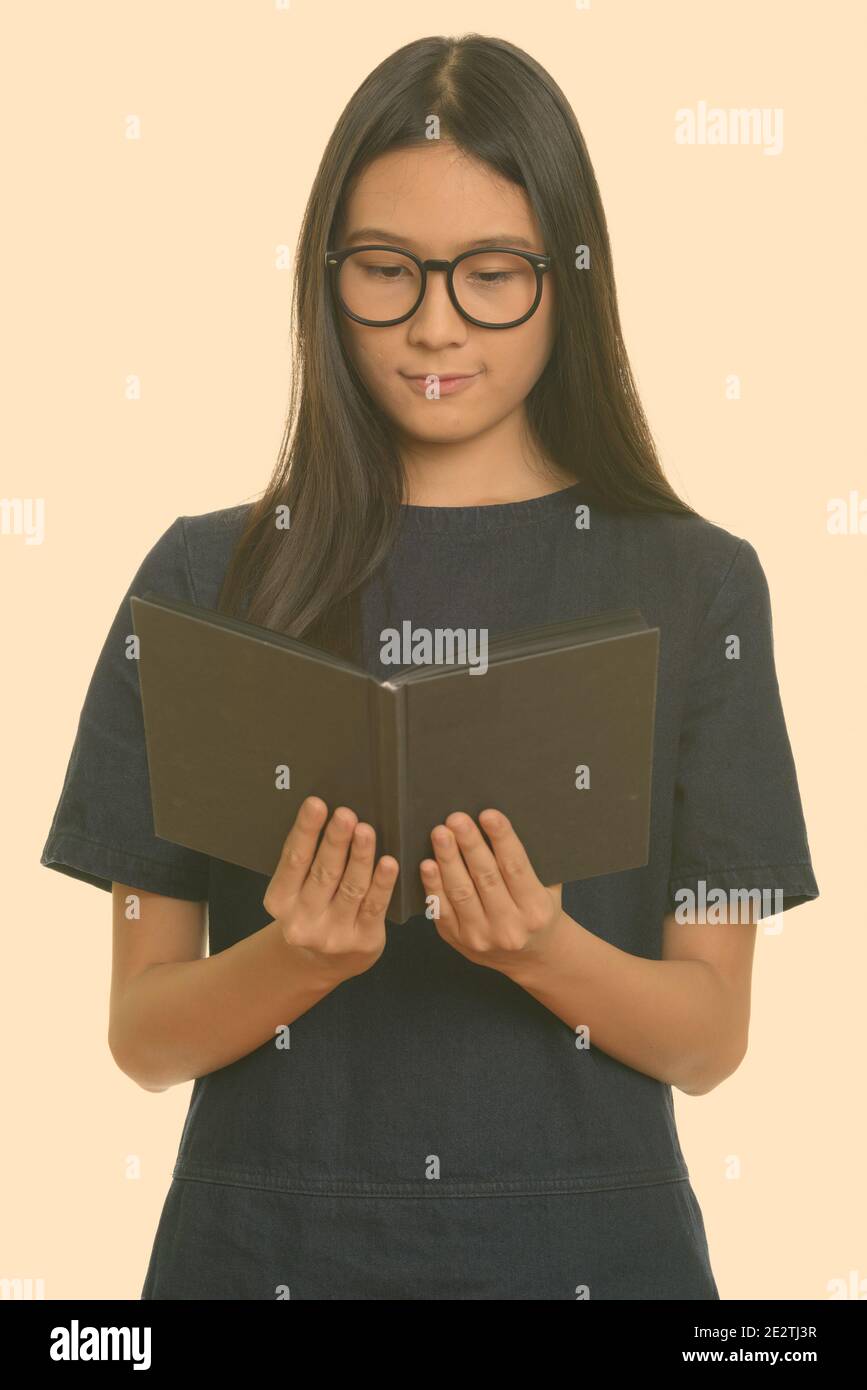 Young beautiful Asian teenage girl reading book Stock Photo - Alamy