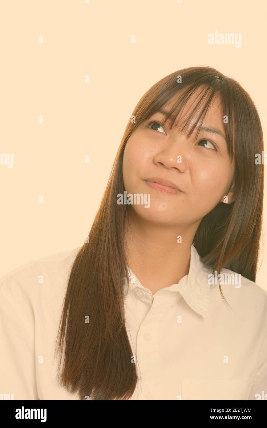Young cute Asian teenage girl thinking Stock Photo - Alamy