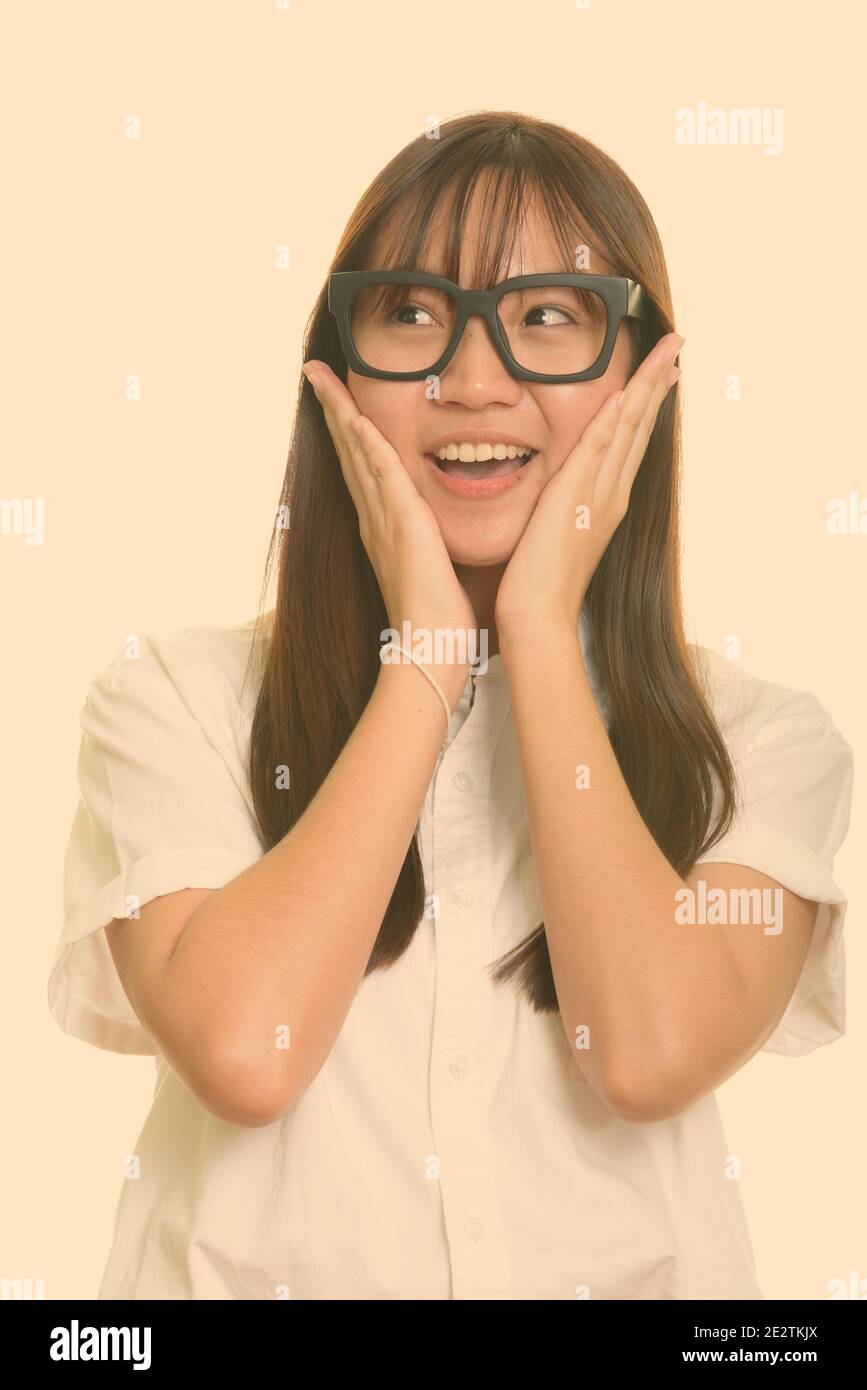 Young happy Asian teenage girl smiling looking surprised Stock Photo ...