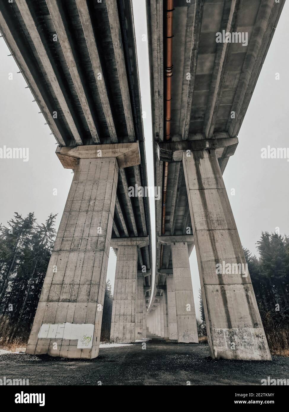Vertical low angle shot of the pillars of a huge bridge Stock Photo - Alamy