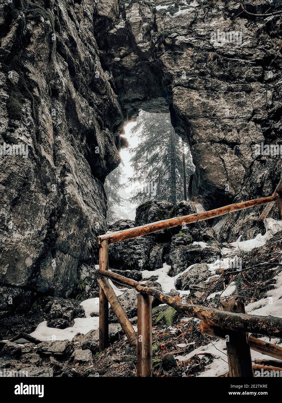Vertical shot of a pathway through the hole of a cliff Stock Photo - Alamy