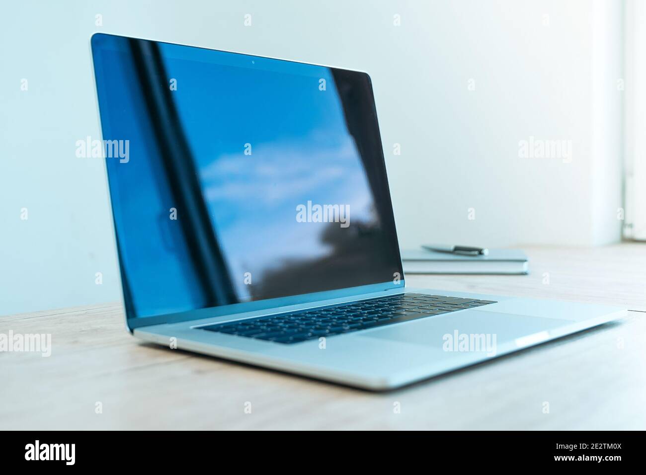 side view. open laptop on the desktop Stock Photo - Alamy