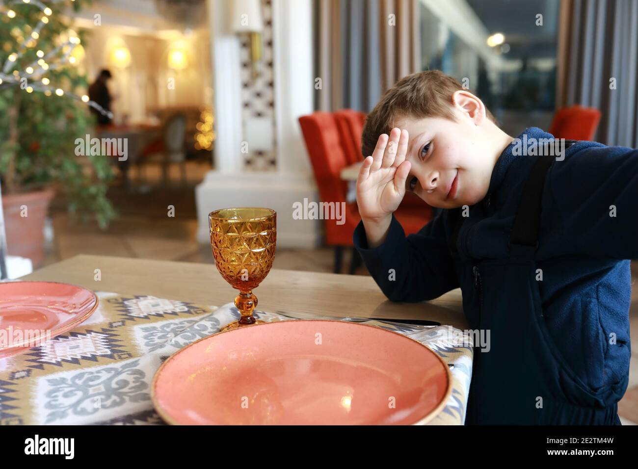 Portrait of child at table in cafe Stock Photo - Alamy