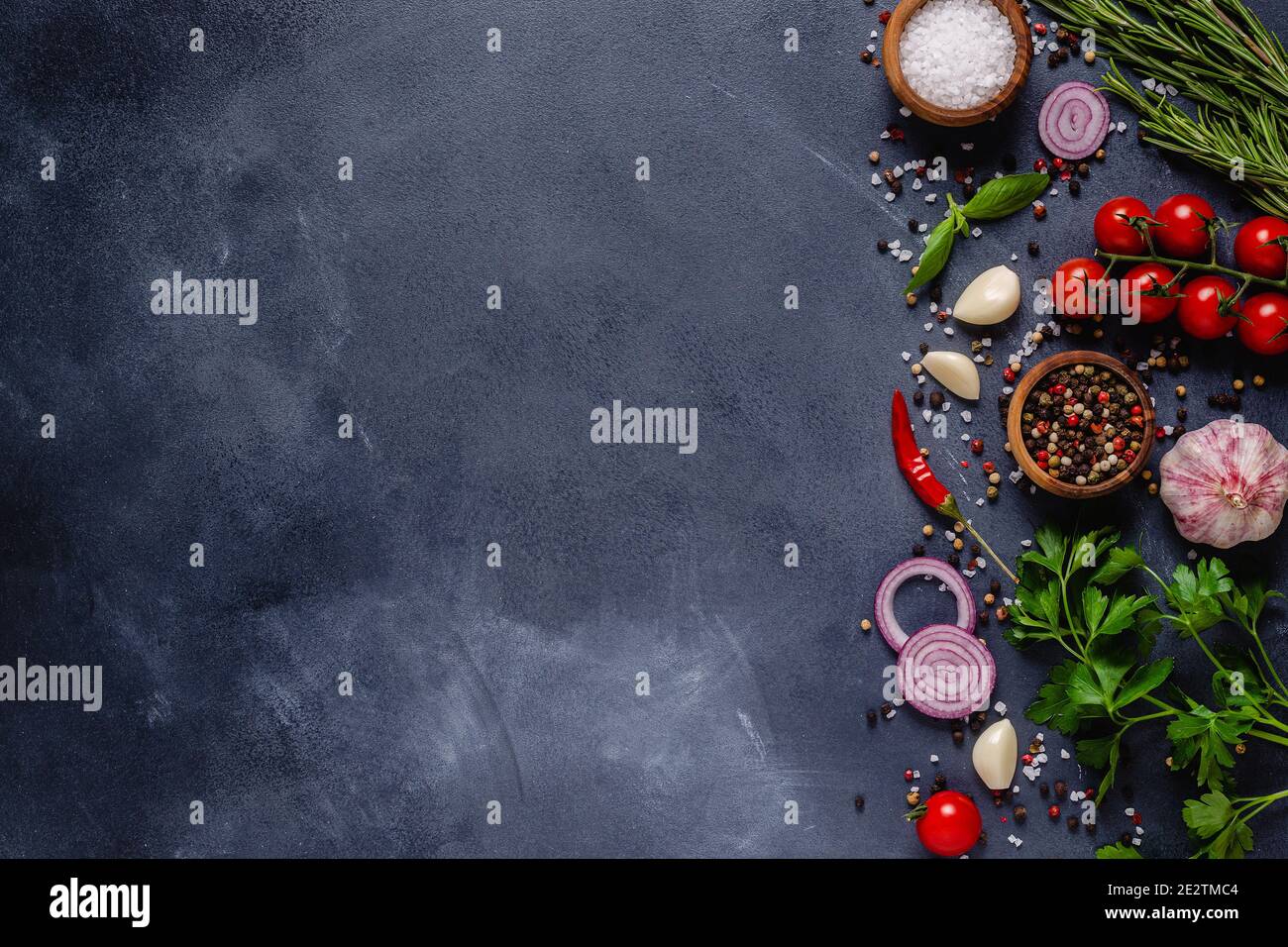 Herbs and condiments on black stone background. Top view with copy ...