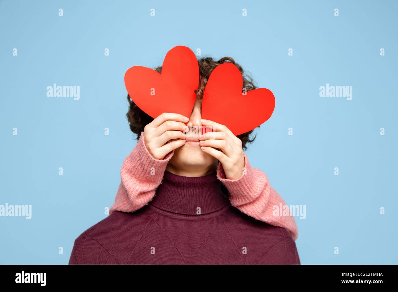 Eyes like heart. Beautiful couple in love on blue studio background ...