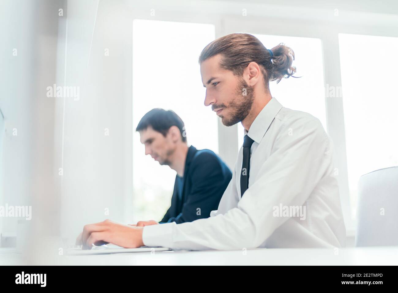 side view. employees work on modern laptops in the office Stock Photo ...