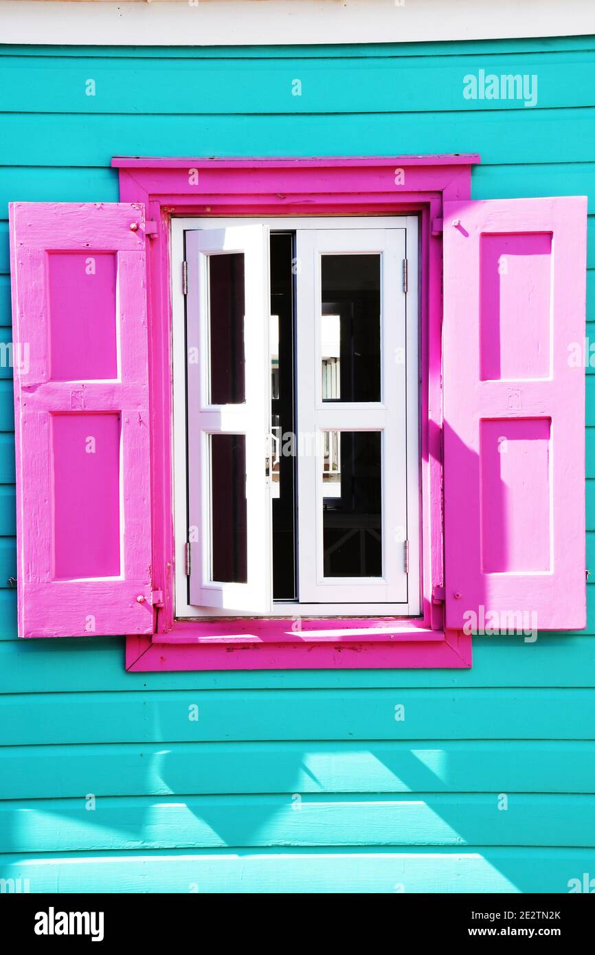 Pink shutters, white window and turquoise Caribbean building Stock ...