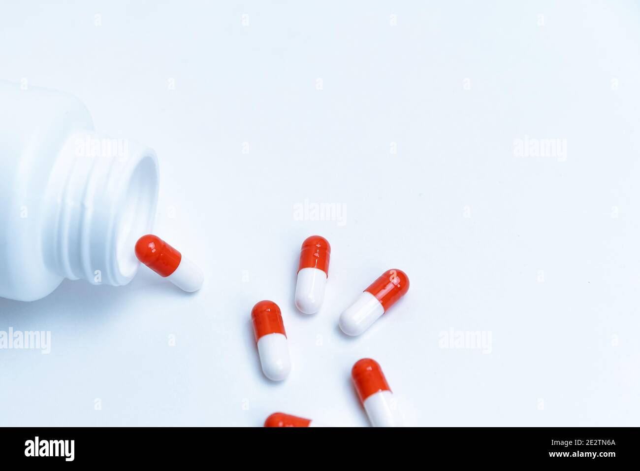capsules with medicine and an empty bottle on a white background Stock ...
