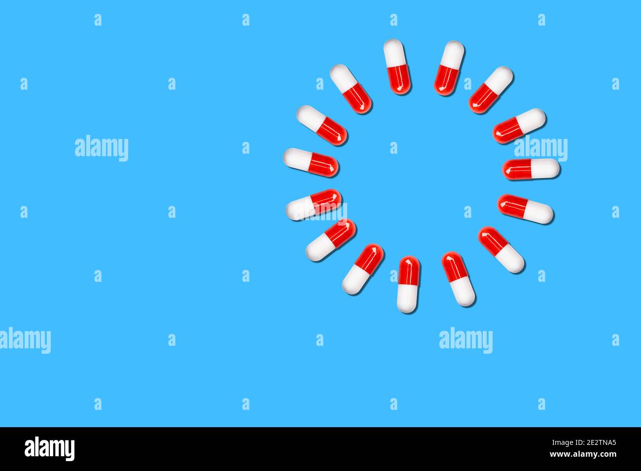 circle of medical capsules on a blue background Stock Photo - Alamy