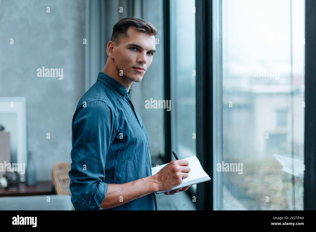Businessman standing window looking distance hi-res stock photography ...
