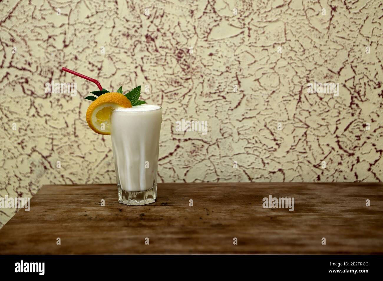 Milk shake on a wall background in cafe Stock Photo - Alamy