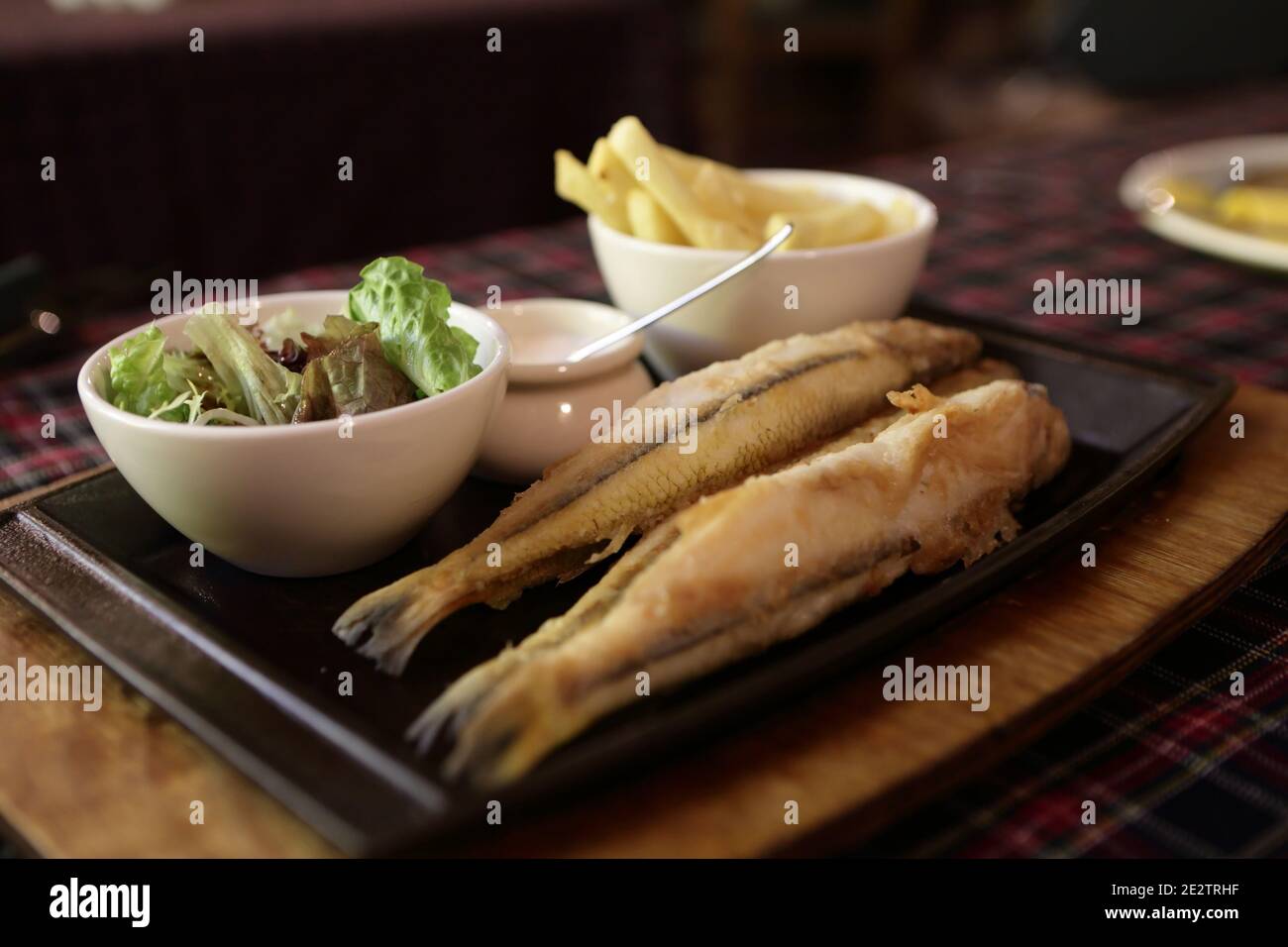 Fried smelt cooked in olive oil in pub Stock Photo - Alamy