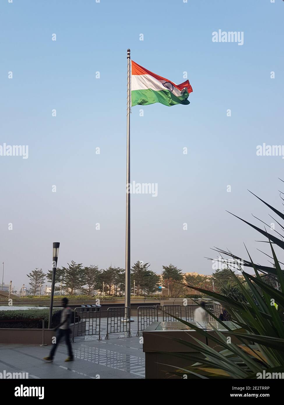 Low angle vertical shot of the Indian flag hanging from a silver pole ...