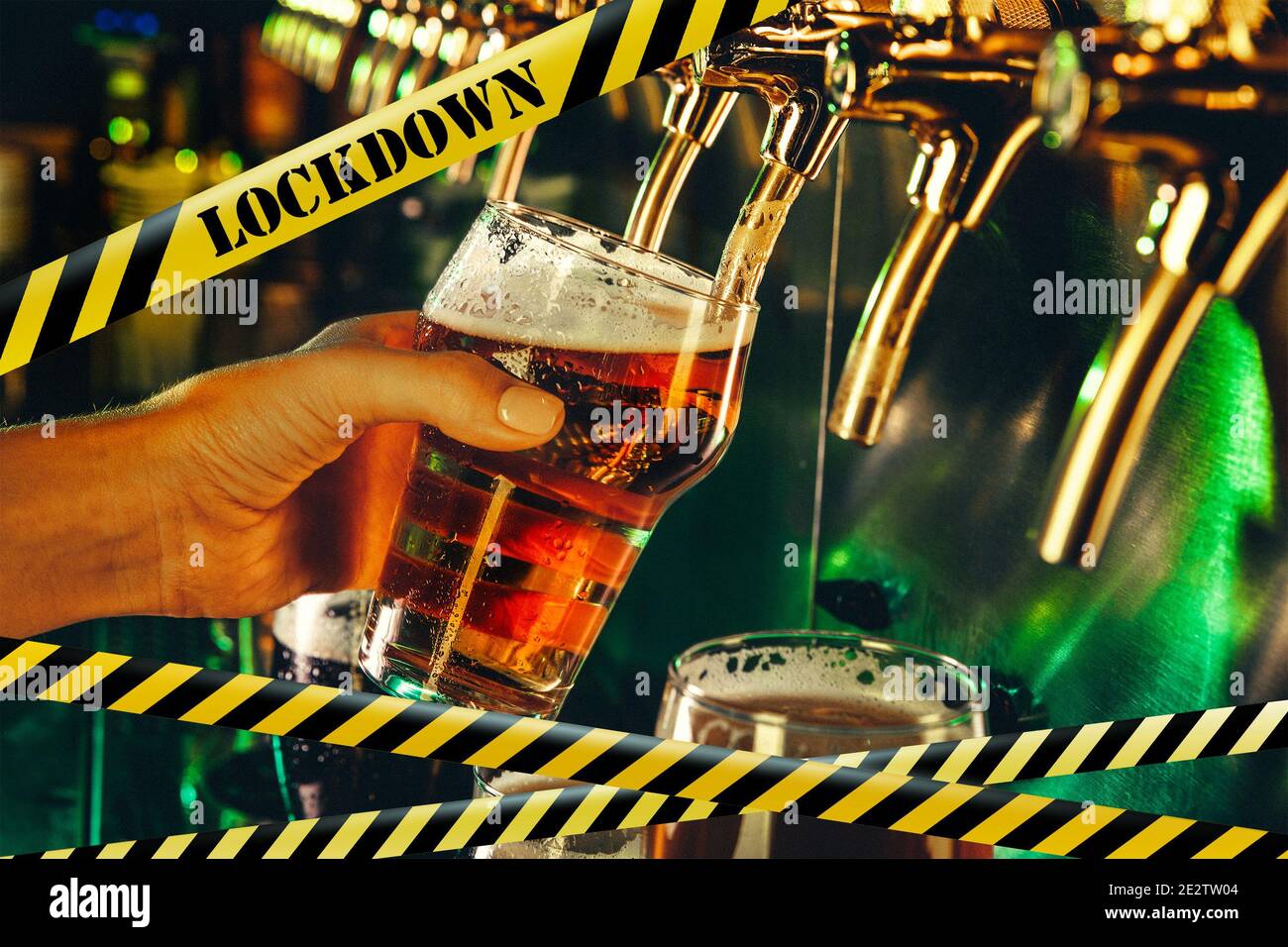 Hand of bartender pouring a beer in tap with bounding tapes Lockdown ...