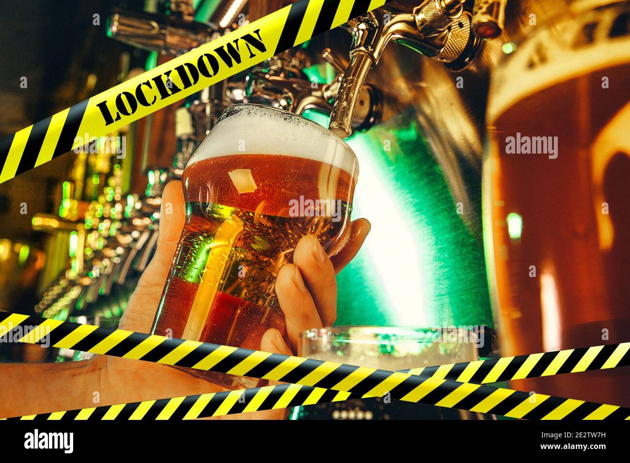 Hand of bartender pouring a beer in tap with bounding tapes Lockdown ...