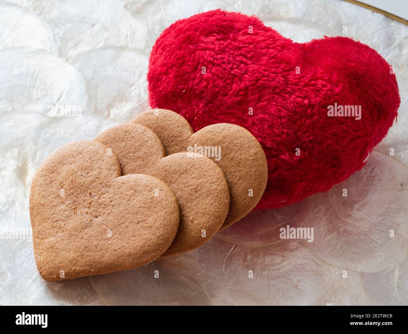 Three heart cookies and a stuffed heart Stock Photo - Alamy