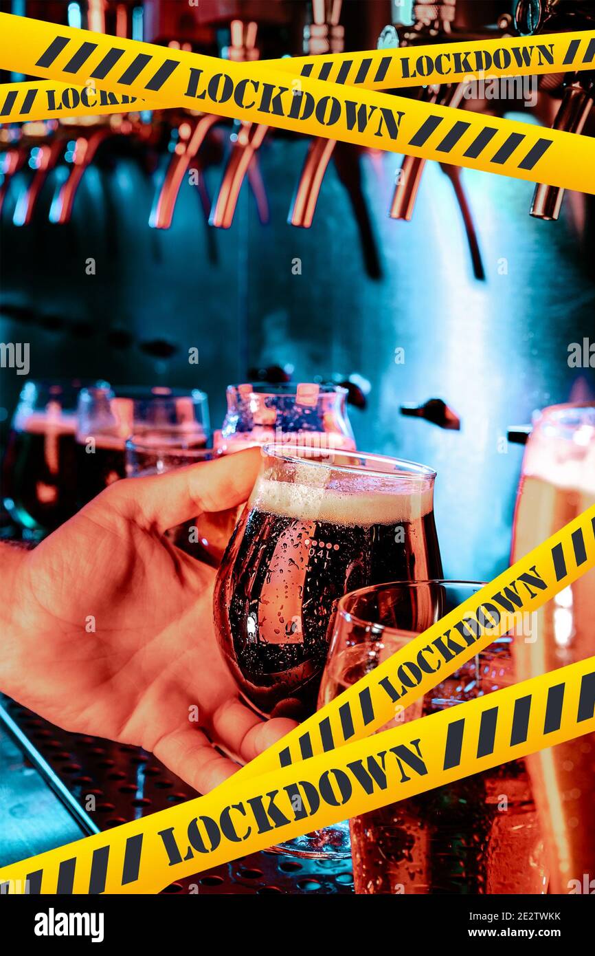 Hand of bartender pouring a beer in tap with bounding tapes Lockdown ...