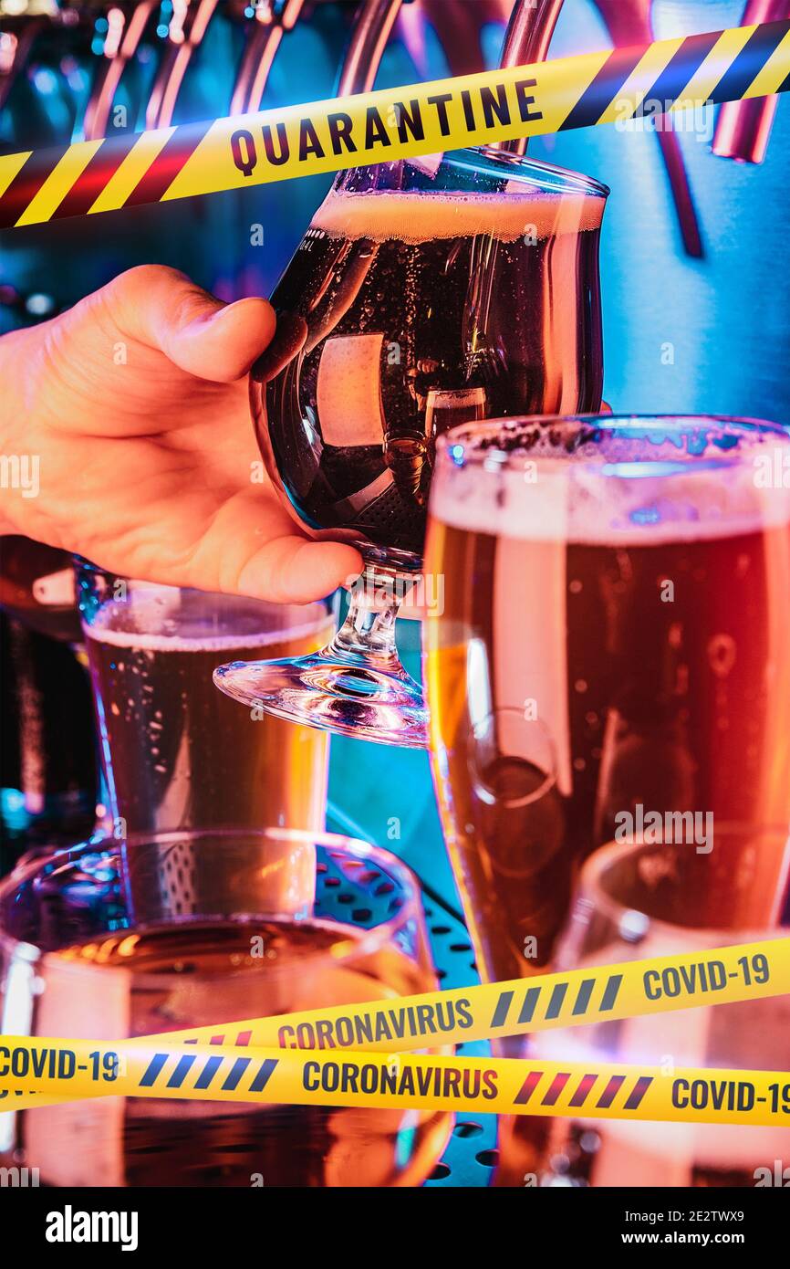 Hand of bartender pouring a beer in tap with bounding tapes Lockdown ...