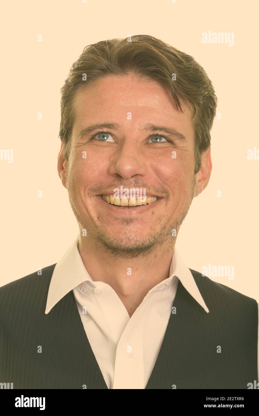 Happy formal Caucasian man thinking wearing vest Stock Photo - Alamy