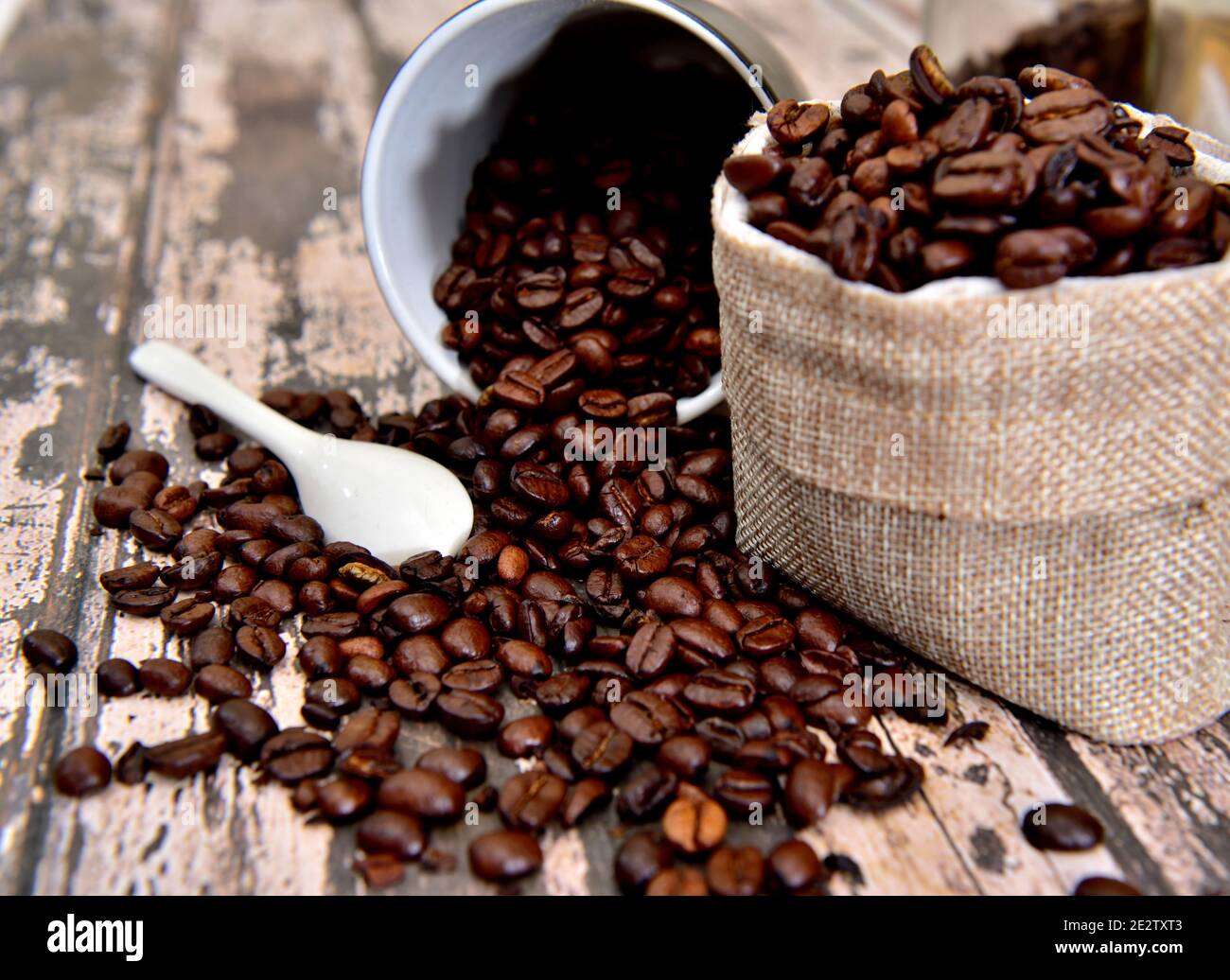 Coffee beans coming out of the mug Stock Photo - Alamy