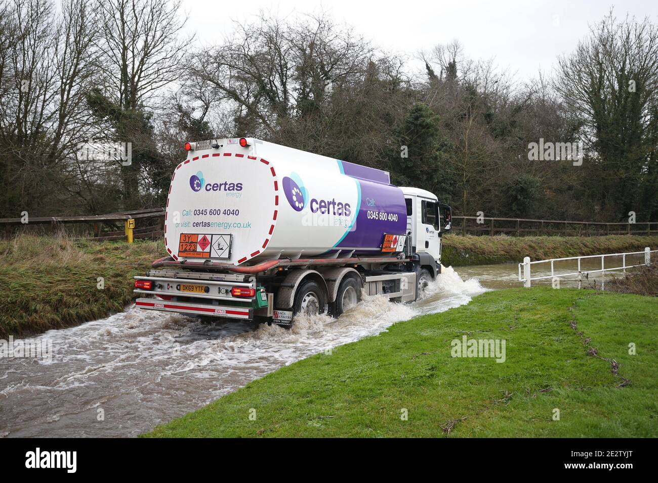 A lorry drives along a flooded road in the village of Great Easton ...