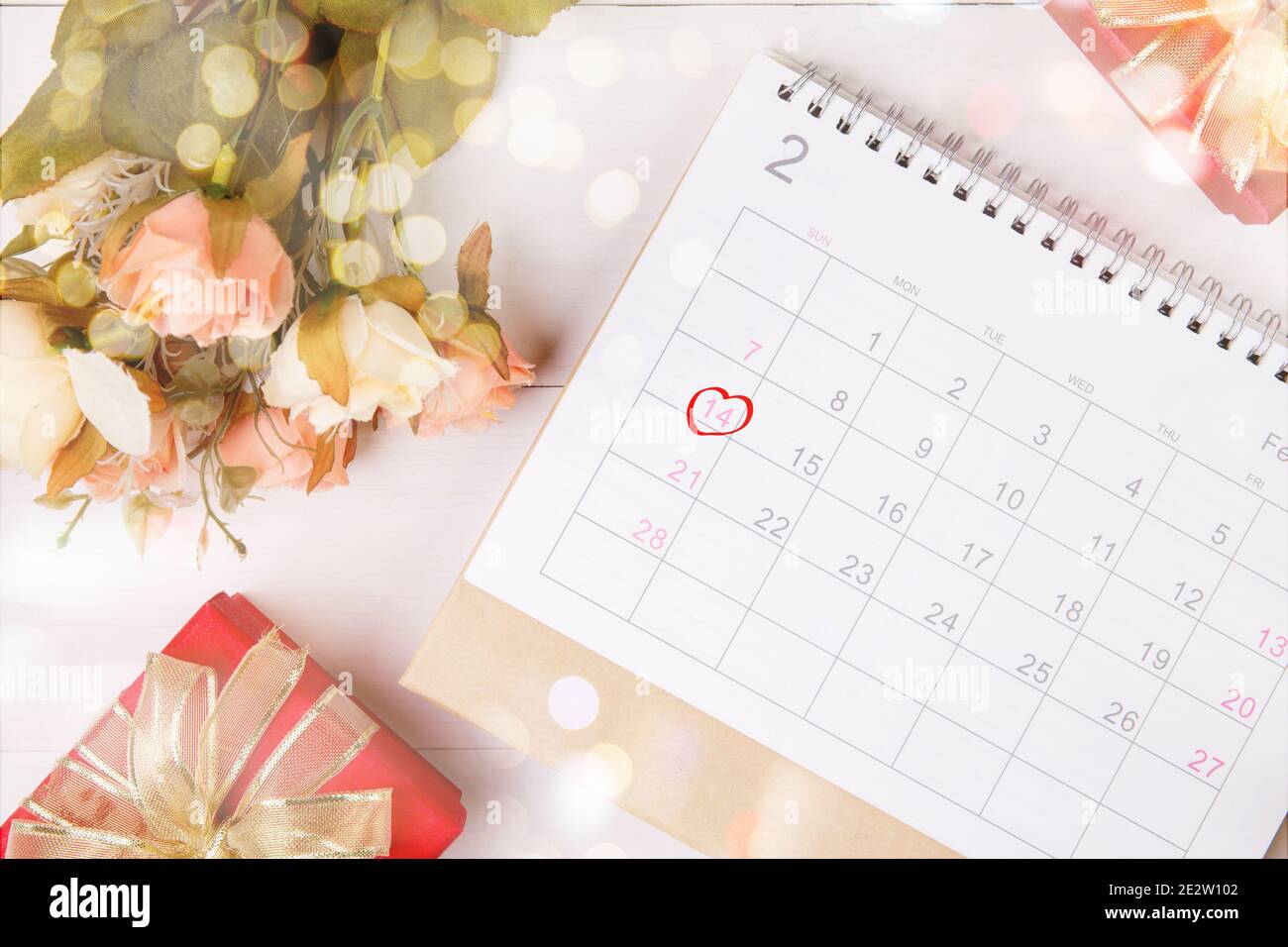 Calendar and flower with memo 14 February Valentine day on desk with ...