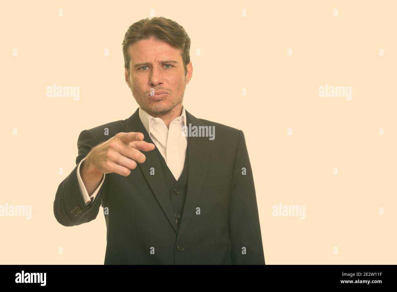 Handsome Caucasian businessman pointing finger while looking angry ...