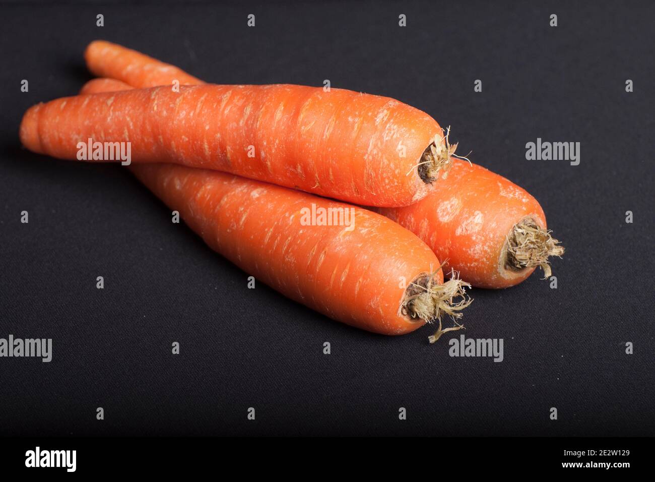 Three fresh carrots black hi-res stock photography and images - Alamy