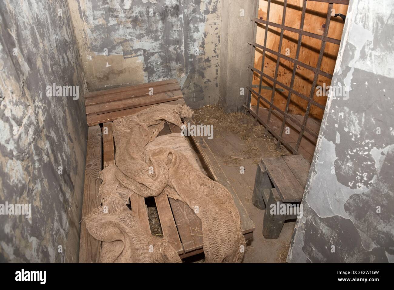 Antique prison cell with bars and bunks Stock Photo - Alamy