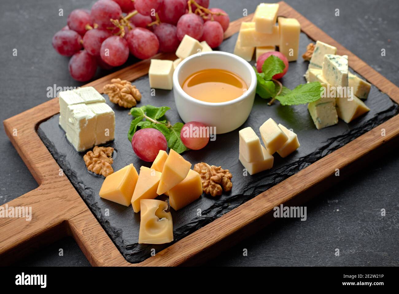 Assorted cheese (cheese board) on a black background Stock Photo - Alamy