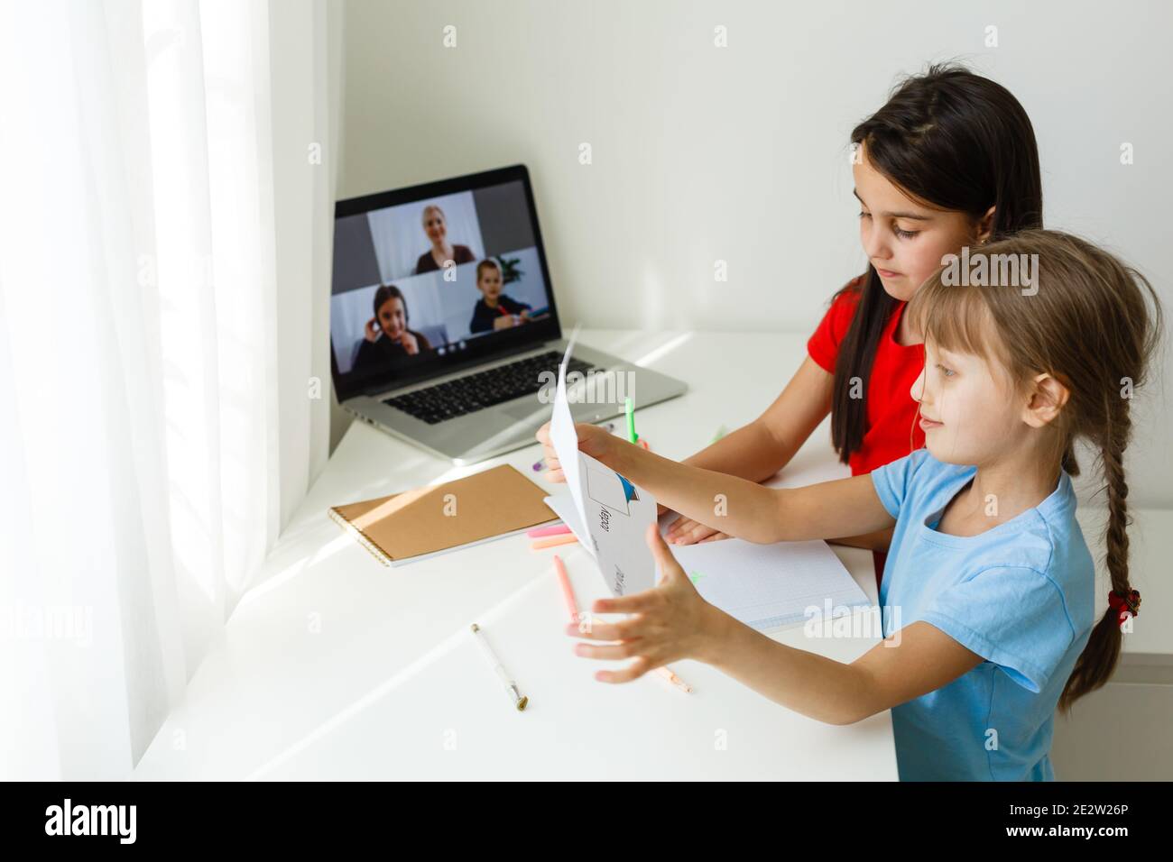 Cool online school. Kids studying online at home using a laptop ...