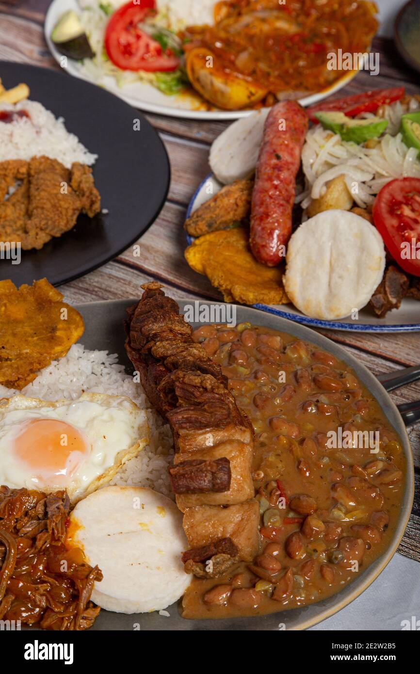 Various dishes of Colombian cuisine on the restaurant table. Vertical ...