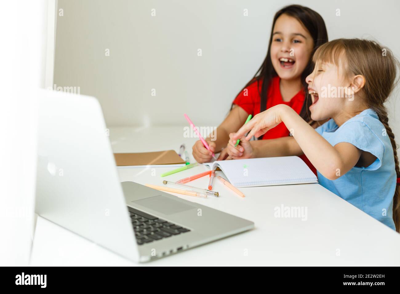 Cool online school. Kids studying online at home using a laptop ...