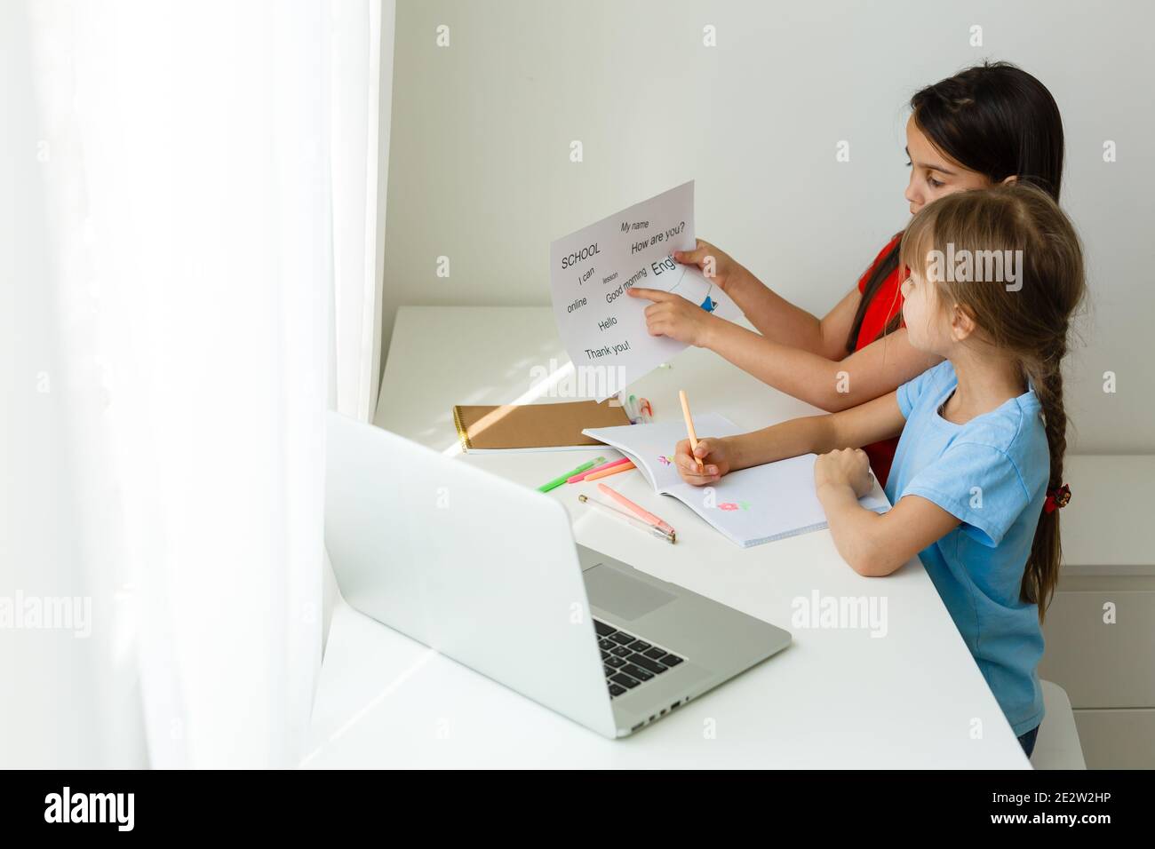 Cool online school. Kids studying online at home using a laptop ...