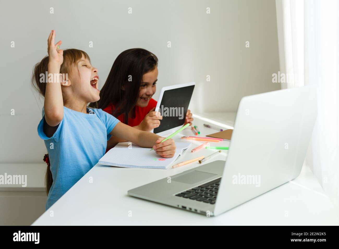 Cool online school. Kids studying online at home using a laptop ...