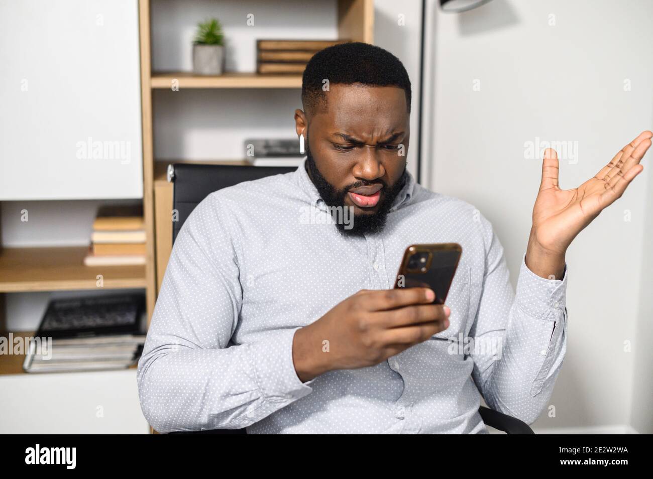 An intelligent African guy in shirt indoor Stock Photo - Alamy