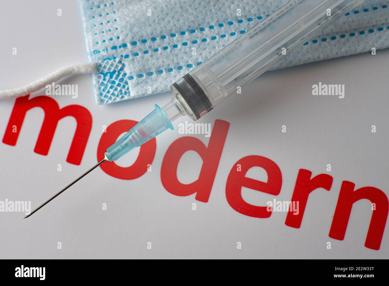 Red moderna sign an a blue syringe on white background, Denmark ...