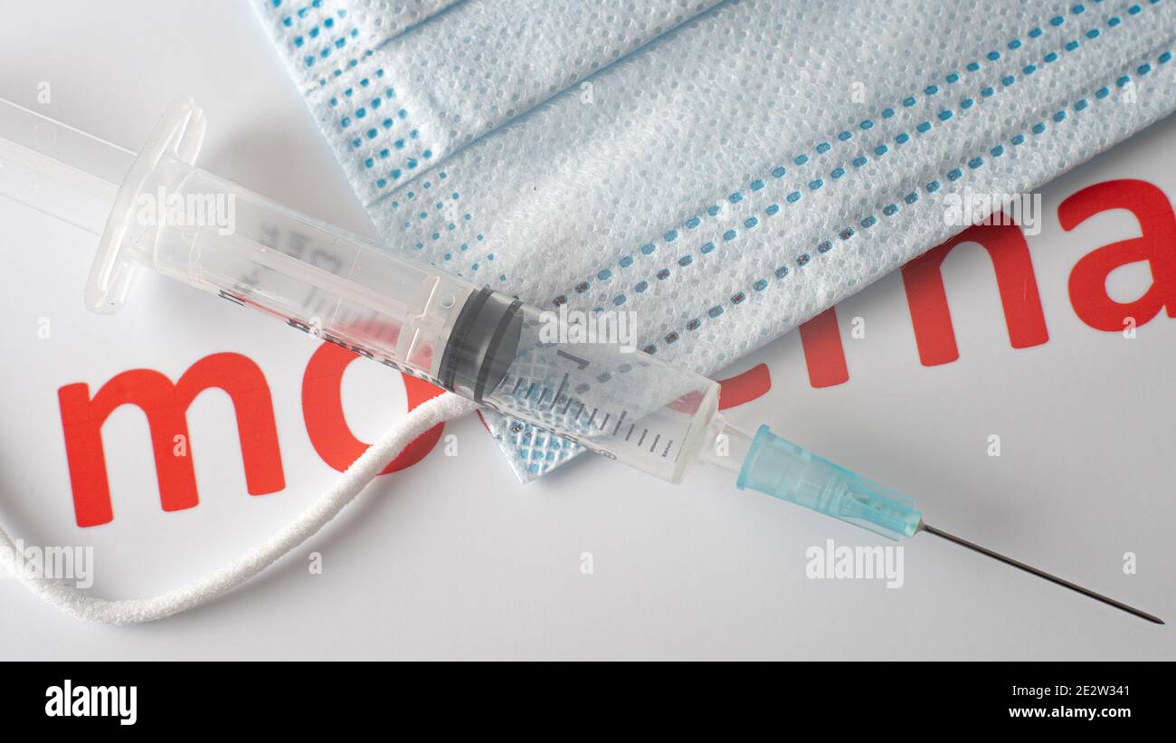Red moderna sign an a blue syringe and a face mask on white background ...