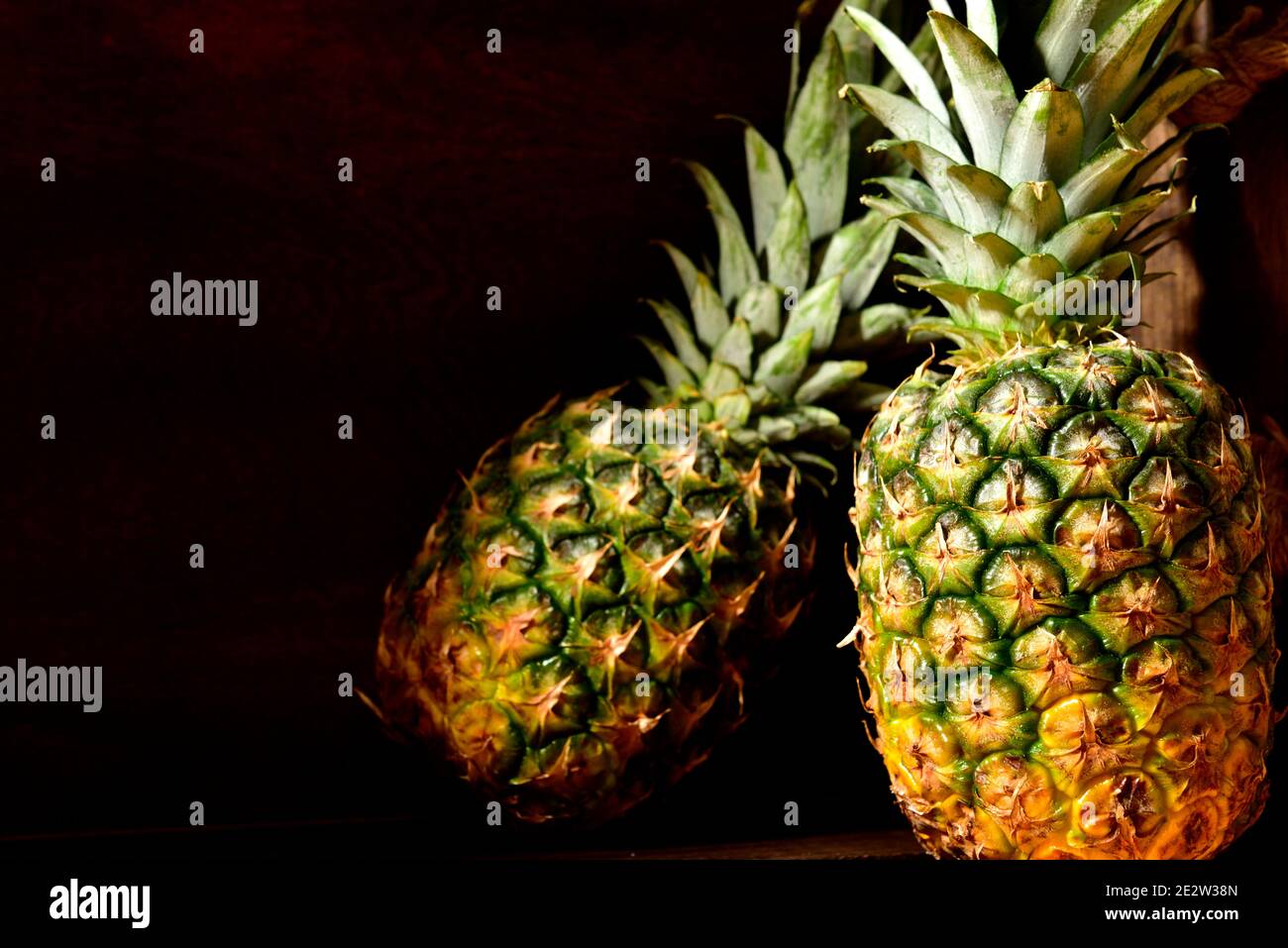 Pineapple in a black background Stock Photo - Alamy