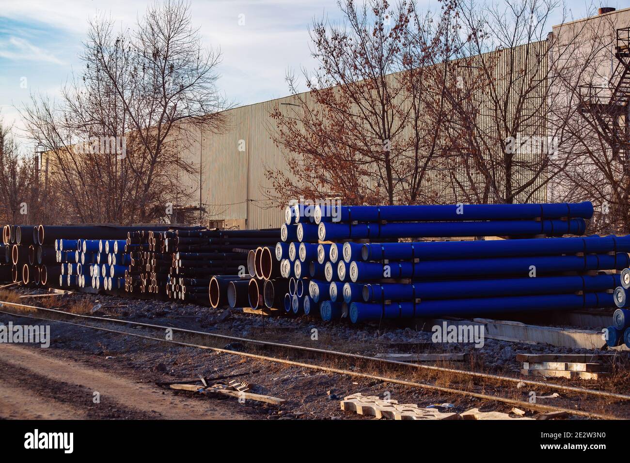 Stack of cast iron pipes in loading area waiting for transportation ...