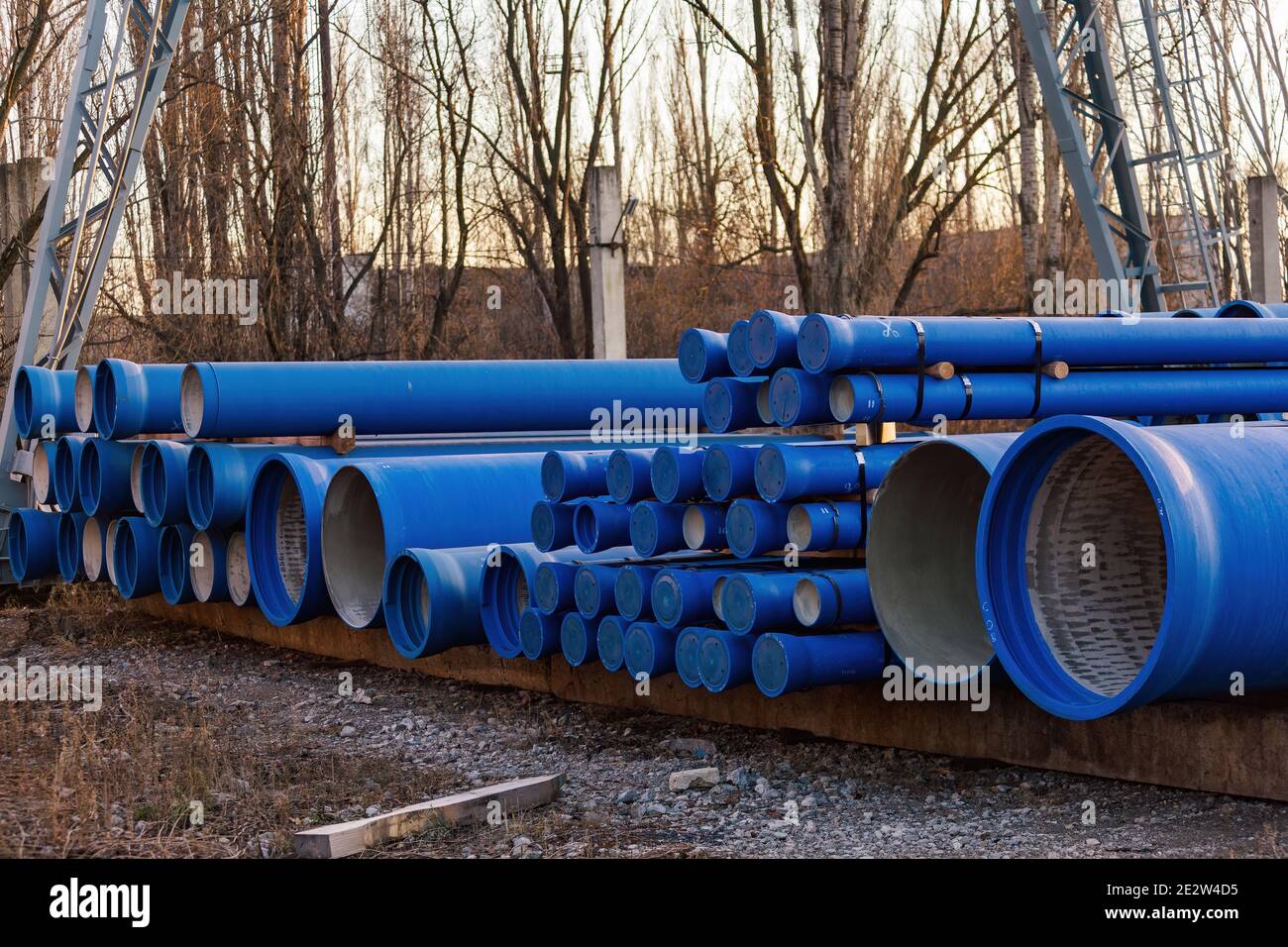 Stack of cast iron pipes in loading area waiting for transportation ...
