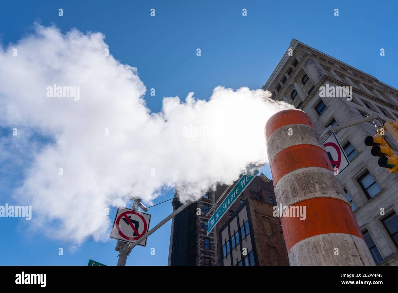 Steam rises and drifts in the blue sky around the Union Square NYC ...